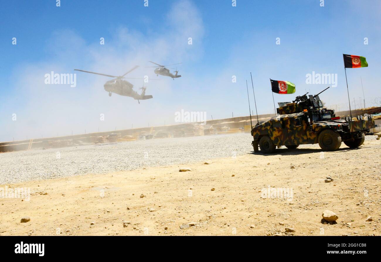 U.S. Army UH-60 Black Hawk helicopters arrive at a mission support site ...