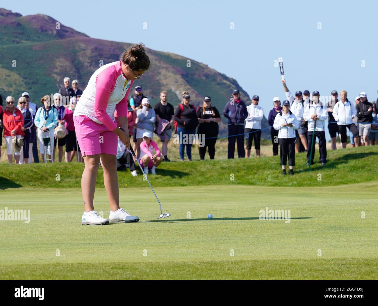 Team GB&I's Emily Toy holes a putt on the 18th green to win a half ...