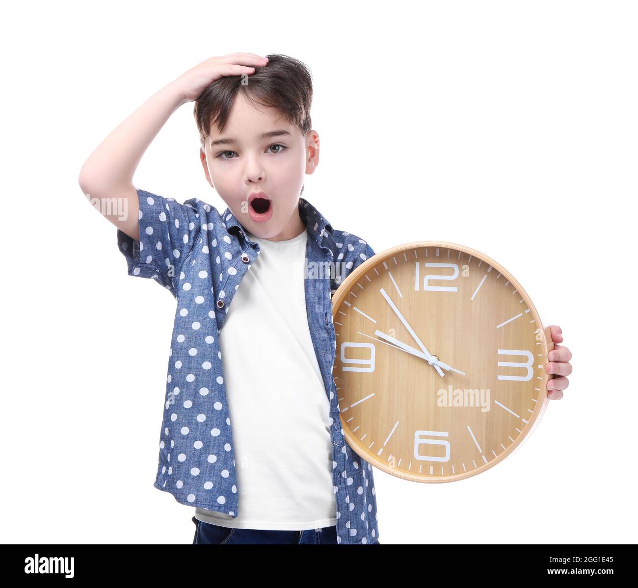 Cute little boy with big clock on white background Stock Photo - Alamy