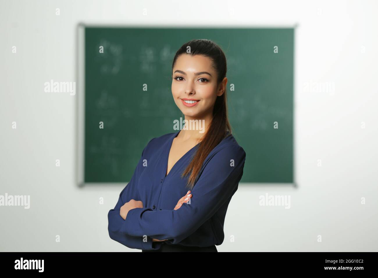 Beautiful young teacher in classroom Stock Photo - Alamy