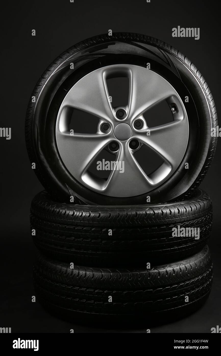 Modern car wheels on dark background Stock Photo - Alamy
