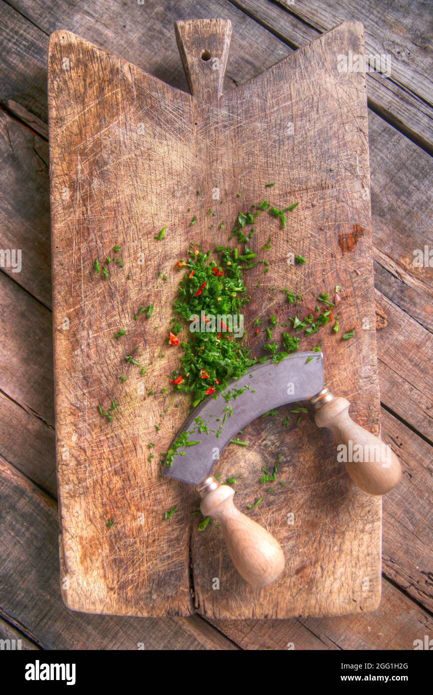 Preparation of chopped chives and chili on wooden-border Stock Photo ...