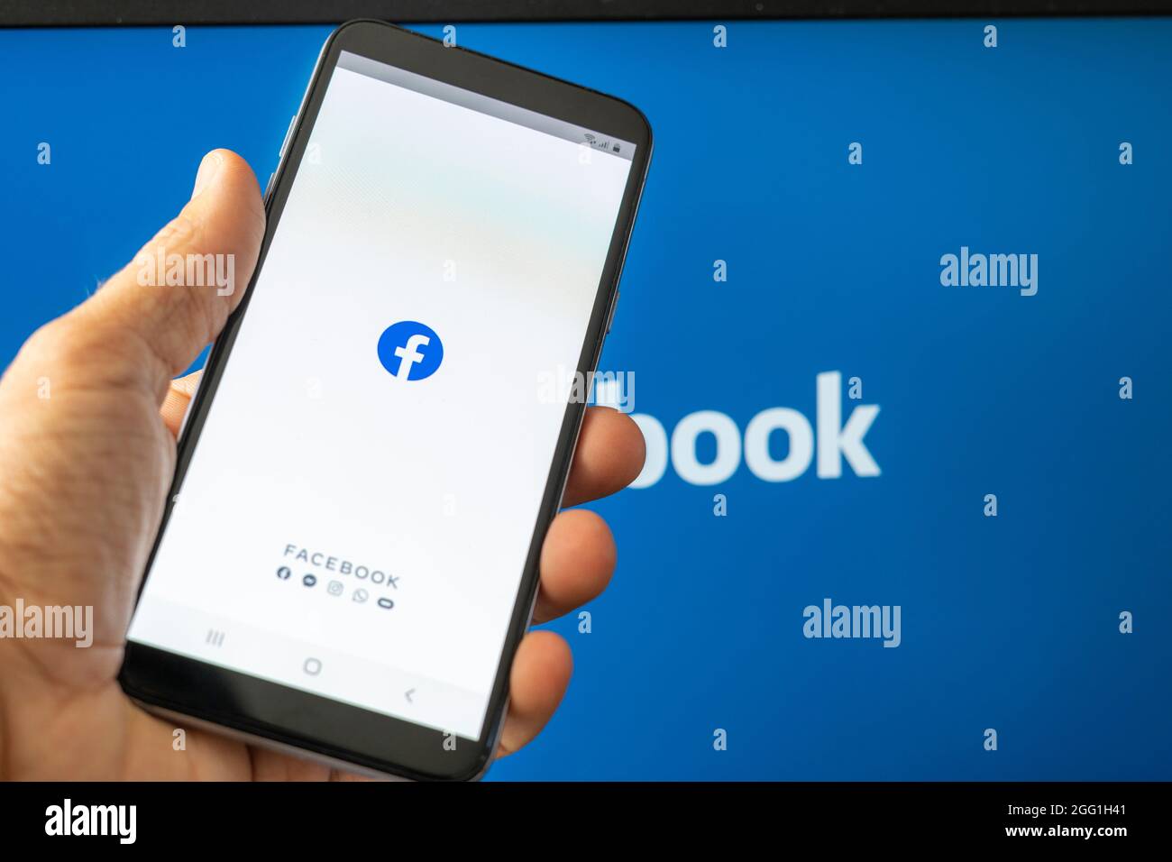 Phone showing facebook app on the screen. Facebook is a photo and video ...