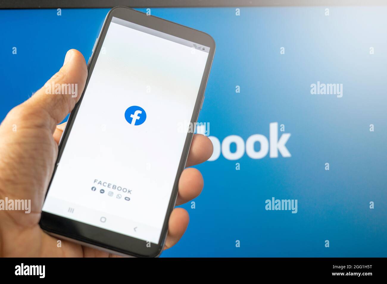 Phone showing facebook app on the screen. Facebook is a photo and video ...