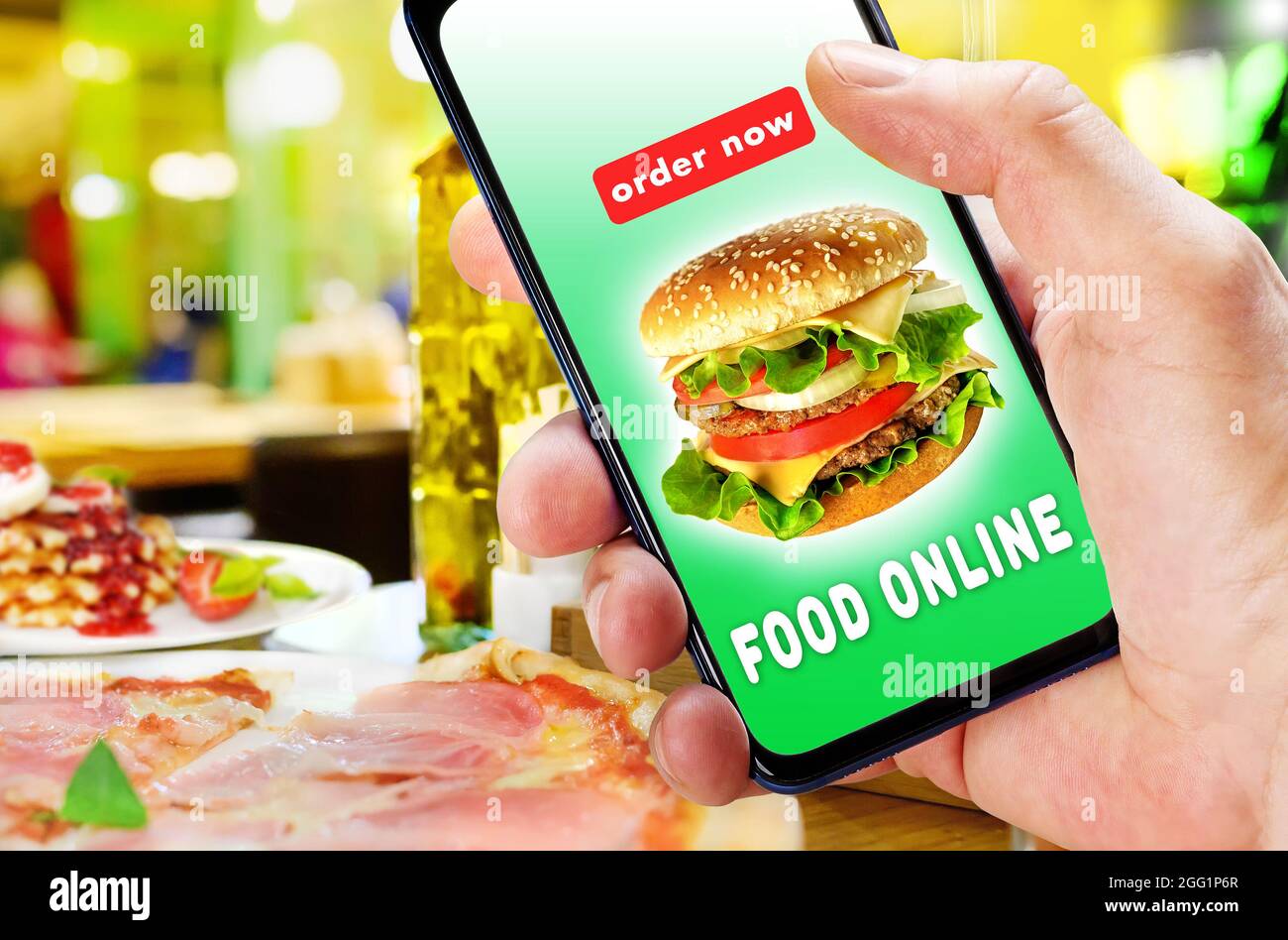 Hand holding phone with app ordering and delivery food over blur ...