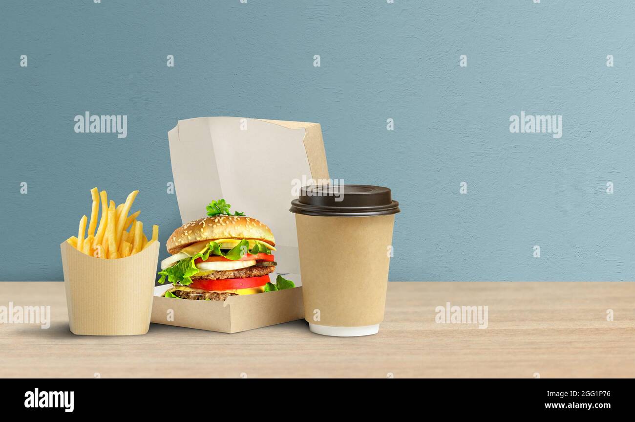 Tasty Hamburger, french fries and coffee in cardboard takeaway ...