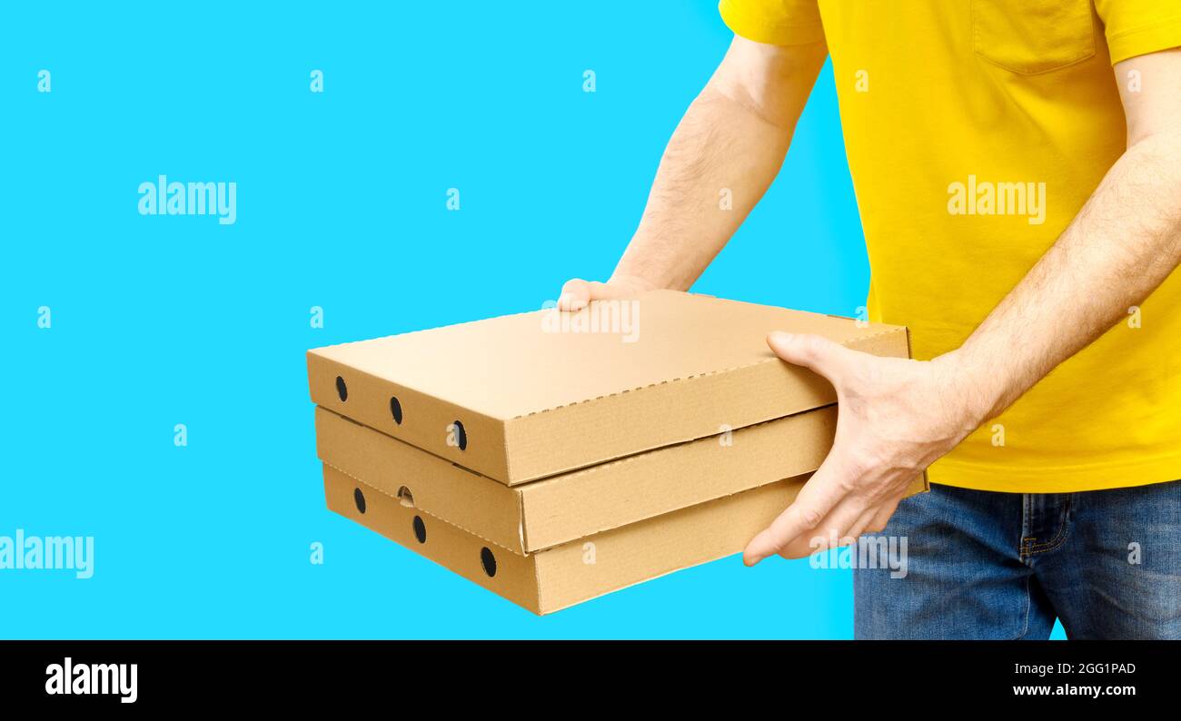 Delivery man is carrying boxes of pizza. Fast Food delivery service ...