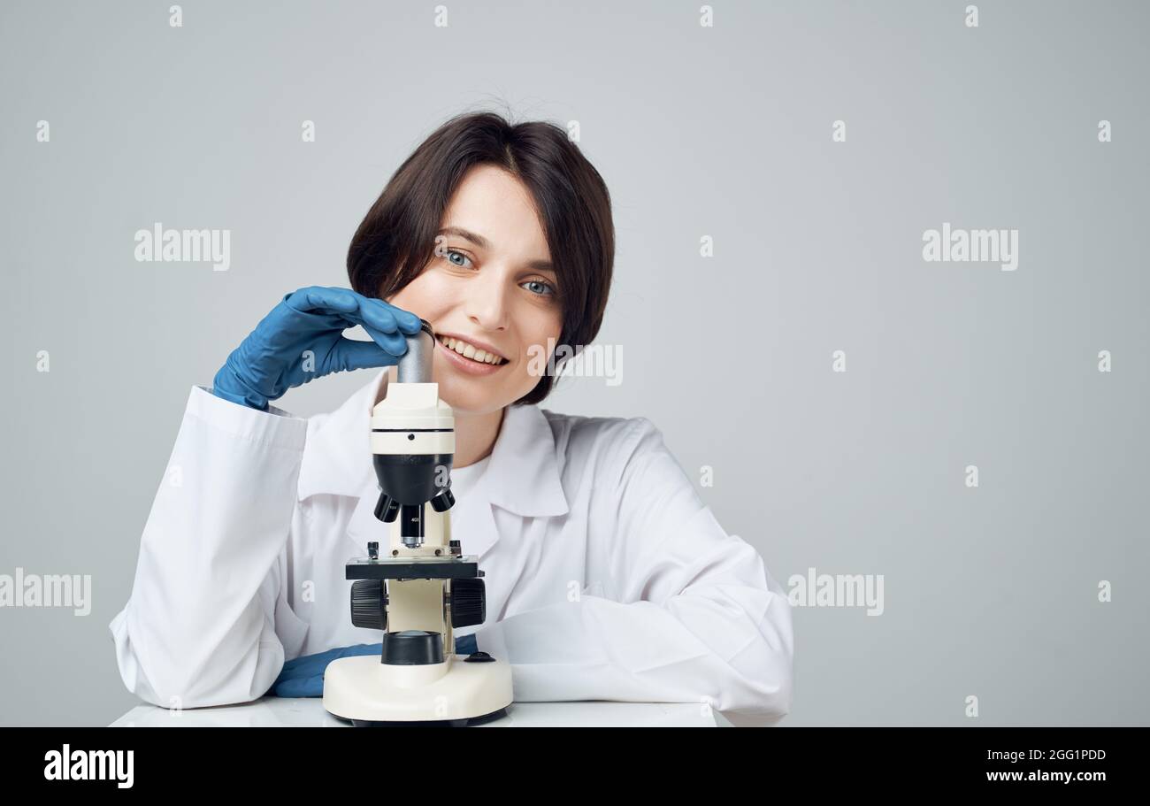 doctor laboratory assistant microscope on research table smile Stock Photo - Alamy