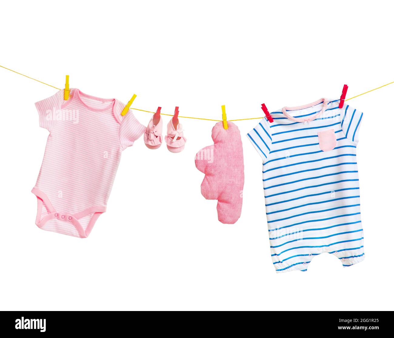 Baby clothes hanging on white background Stock Photo - Alamy