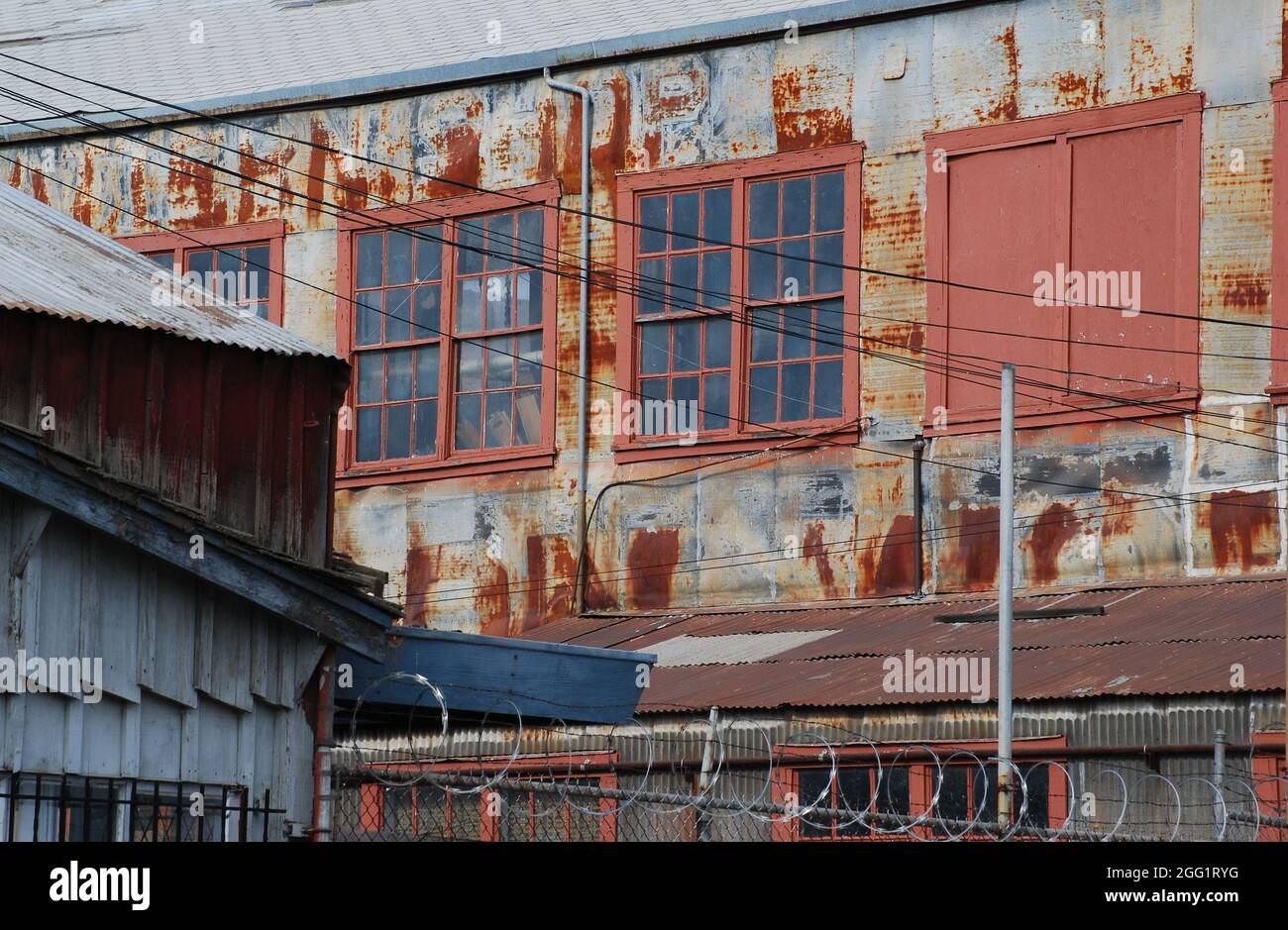 A dilapidated factory decays in a small town in California, as rust ...