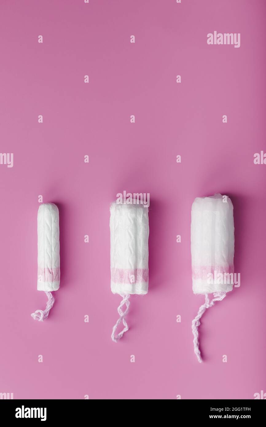 Cotton tampons on a pink background with a free space. Top view, flat ...
