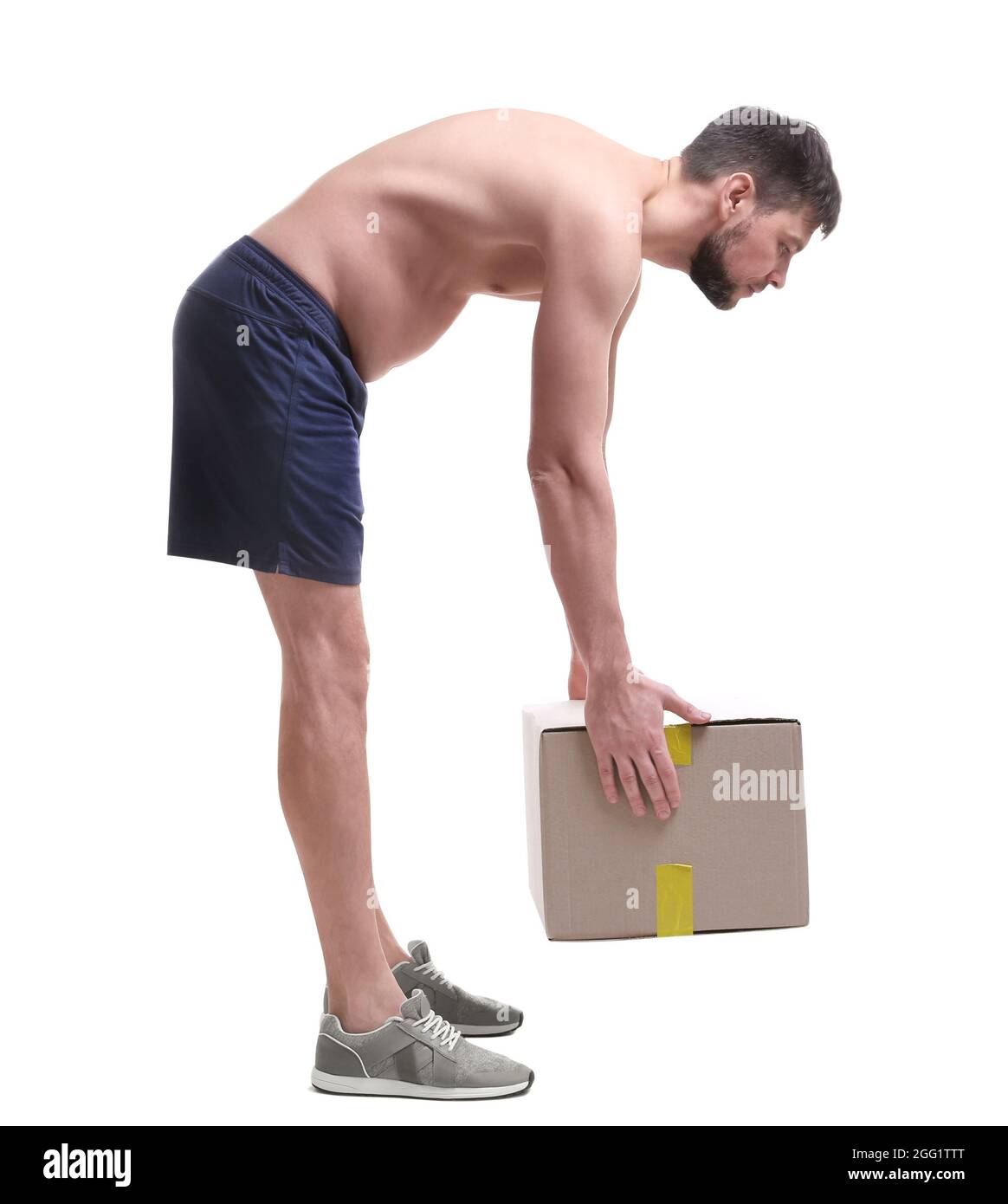 Posture concept. Man lifting heavy cardboard box against white ...