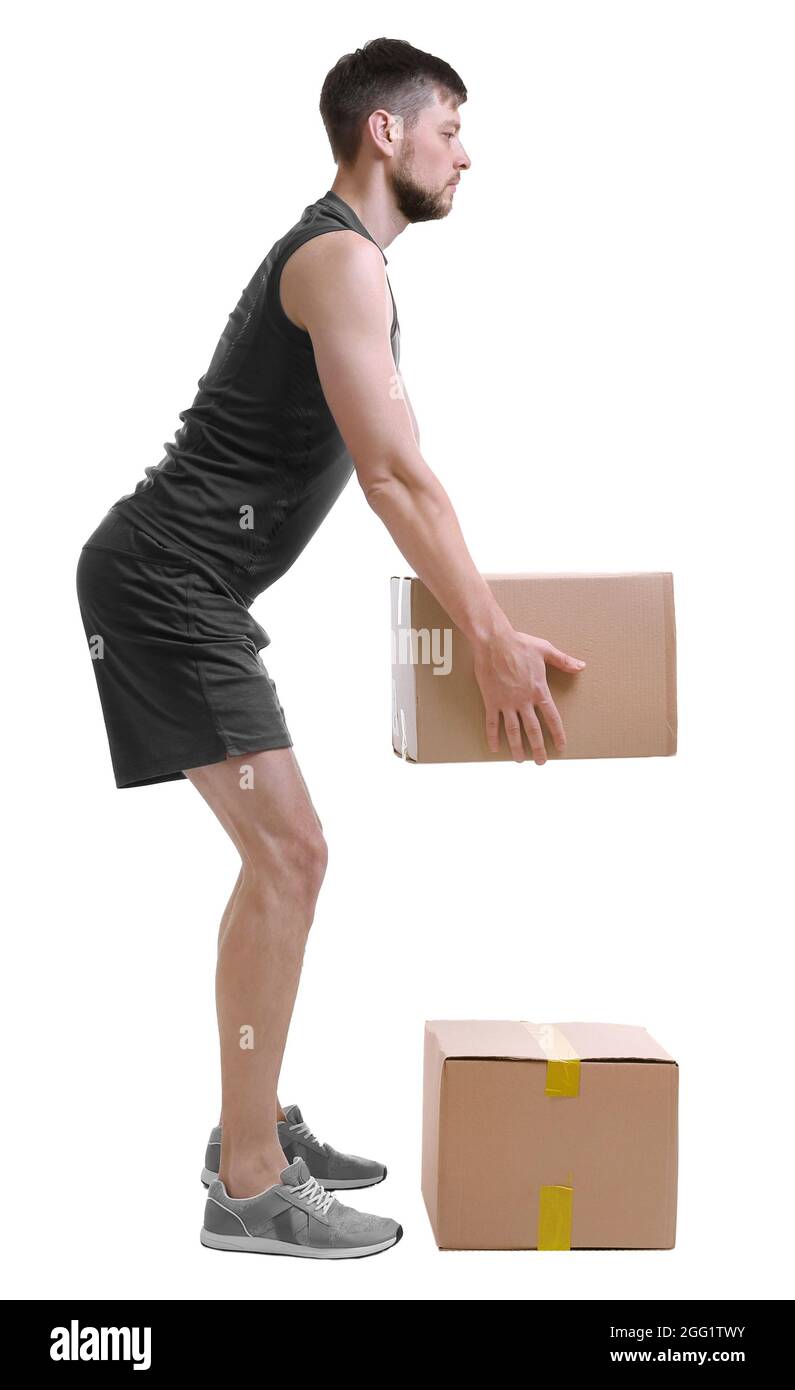 Man lifting heavy boxes Cut Out Stock Images & Pictures - Alamy