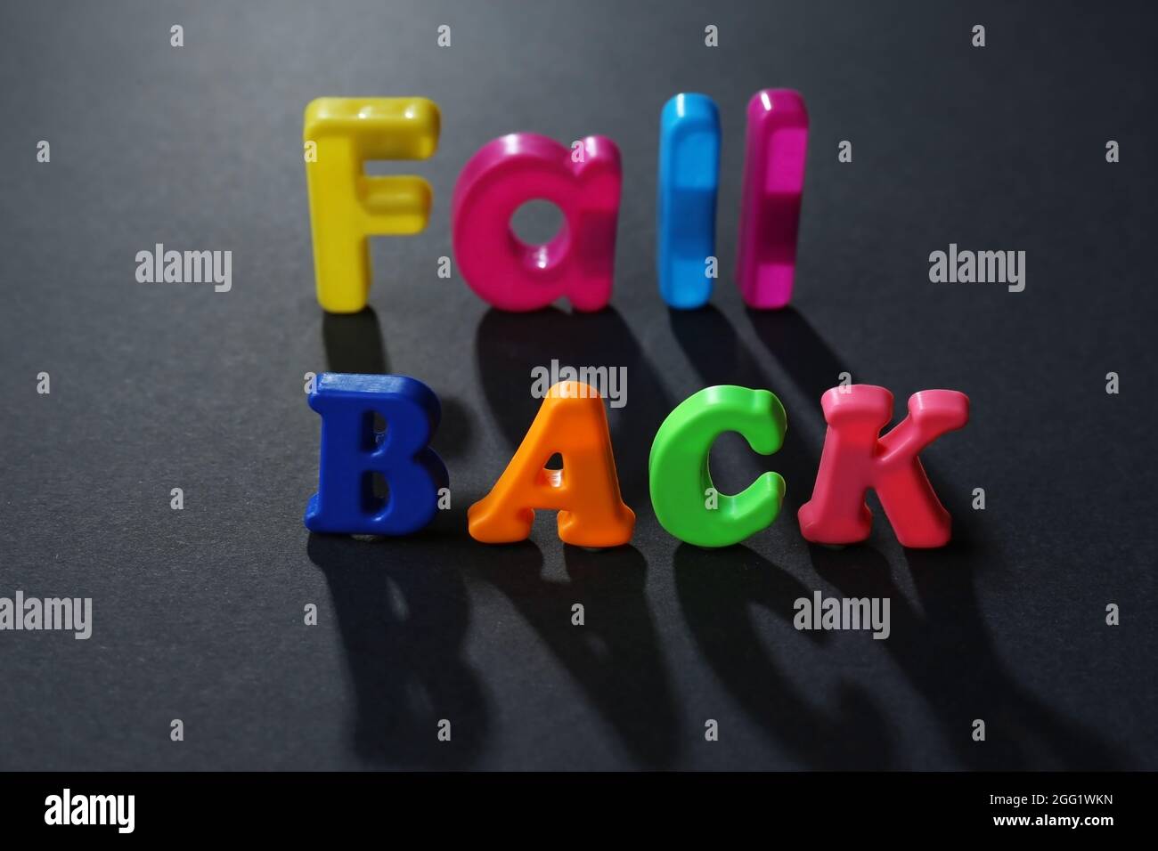 Phrase FALL BACK on chalkboard background Stock Photo - Alamy