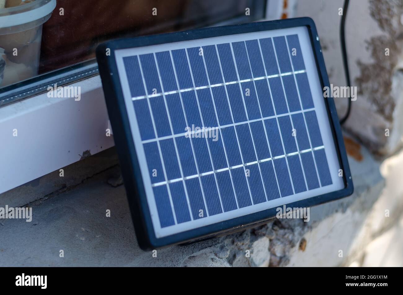 Solar panel on windowsill. Small solar battery. Charging your laptop ...