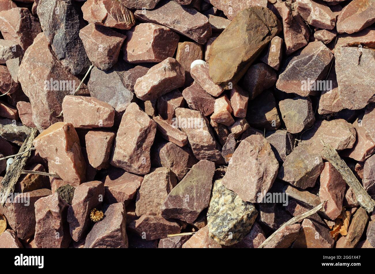 Crimson Quartzite. Chipped rubble stone. Random pieces of red stones ...