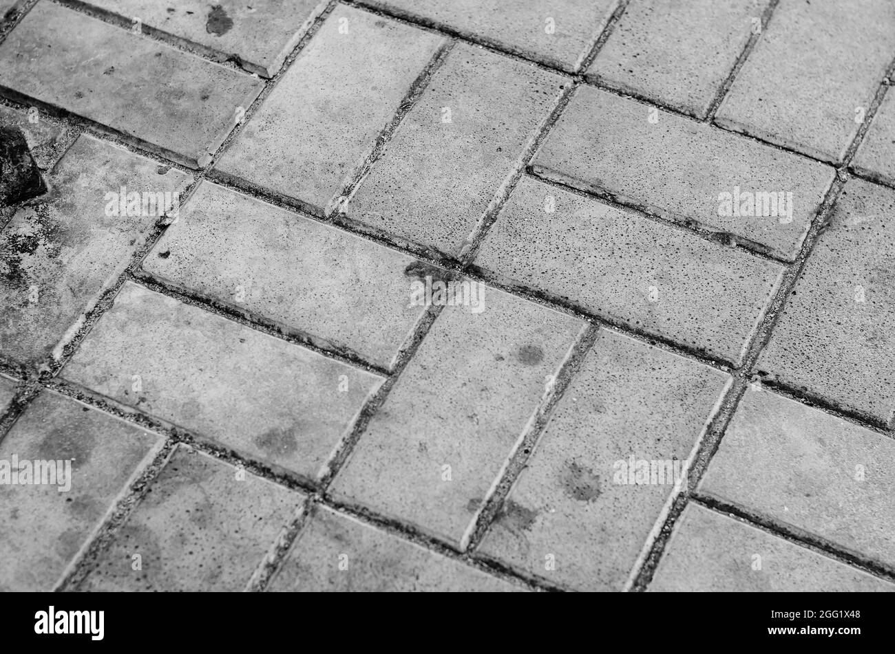 Dirty Sidewalk covered with gray pentahedral tiles. Geometric ...