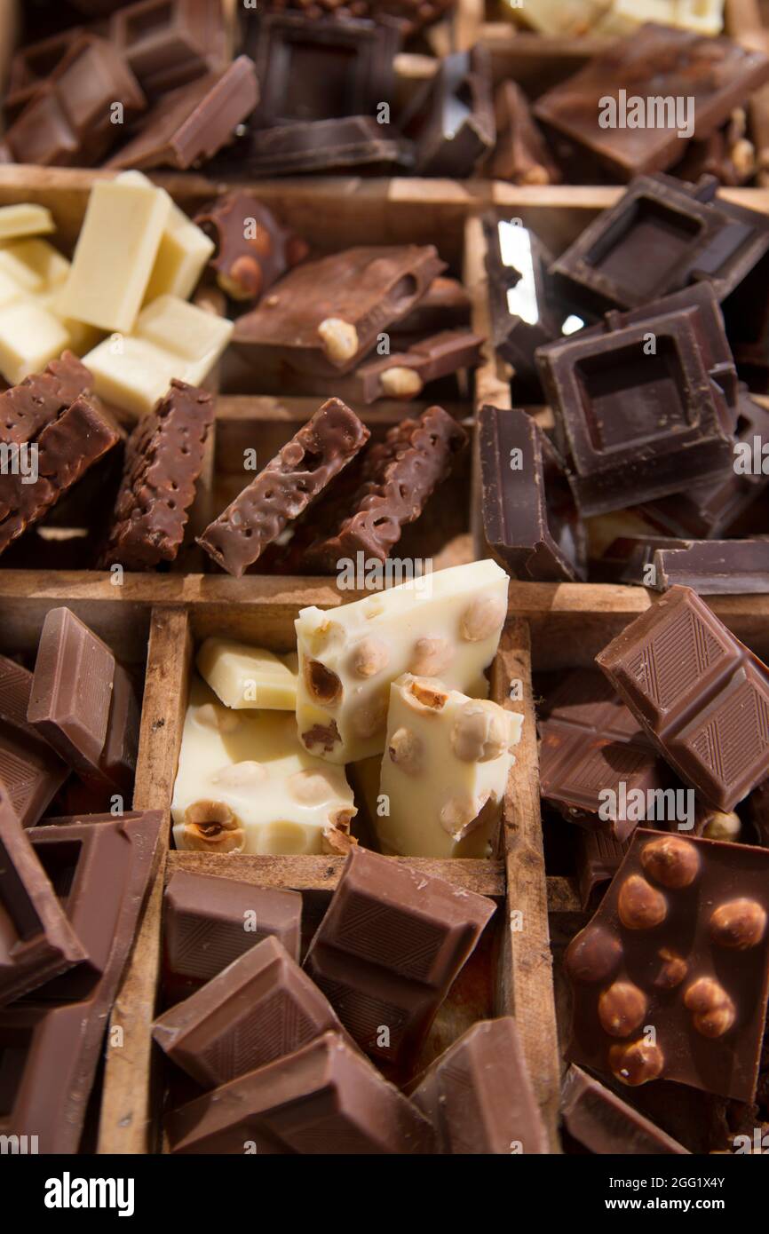 Little cubes of chocolate in various colors in wooden box Stock Photo ...