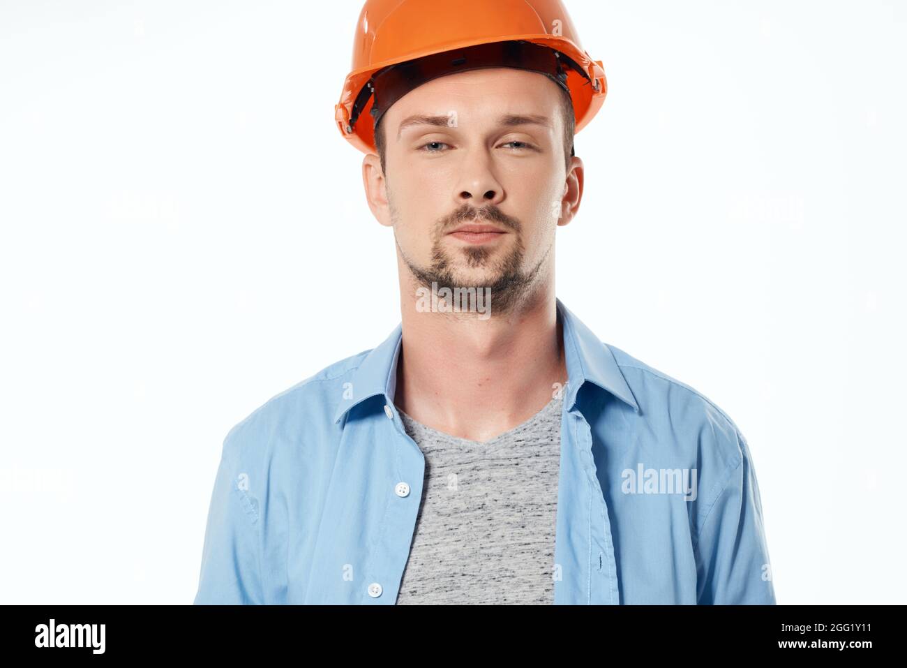 man in orange helmet blueprints builder light background Stock Photo ...