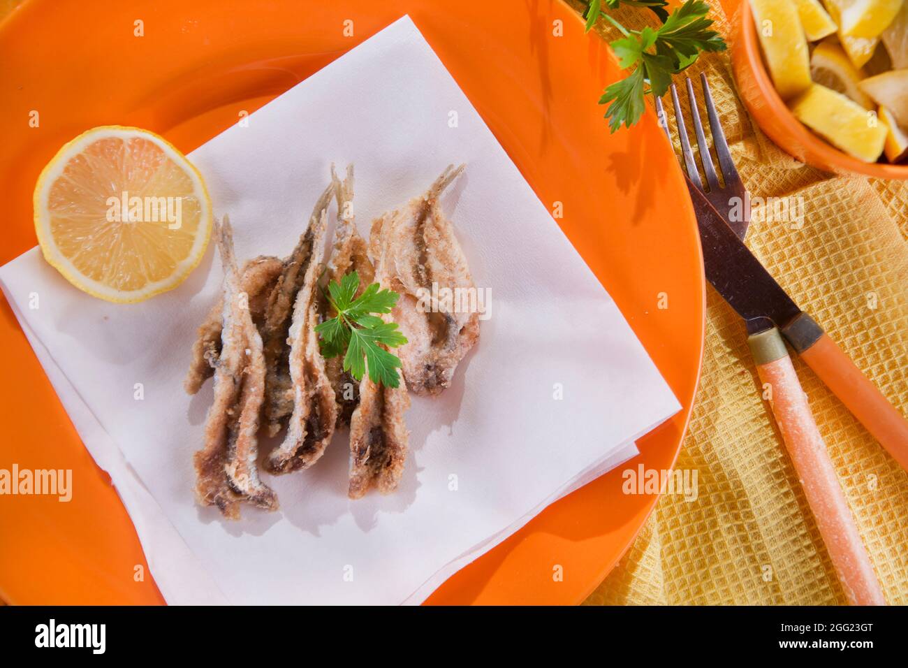 Presentation of a seafood platter, fried anchovies Stock Photo - Alamy