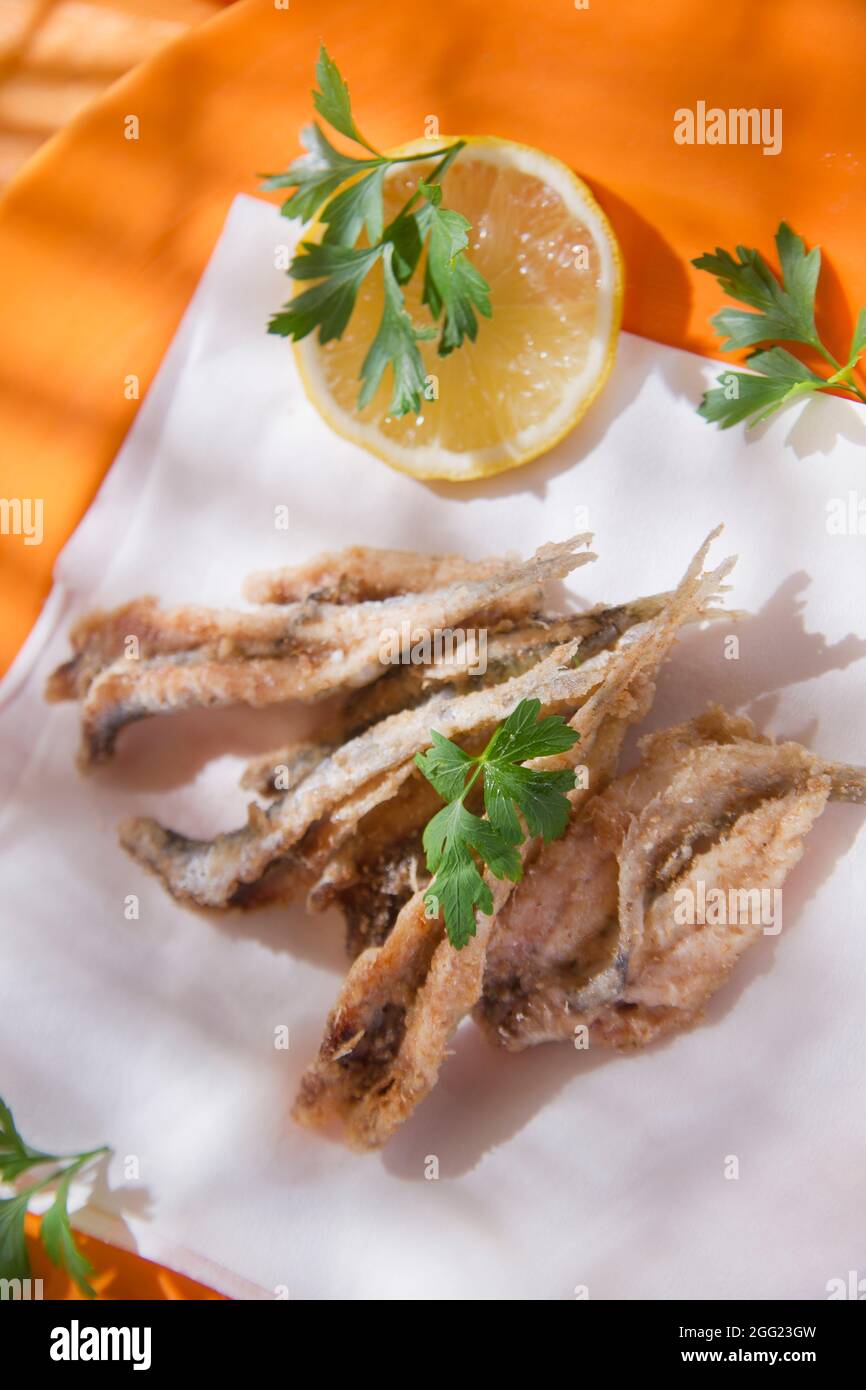 Presentation of a seafood platter, fried anchovies Stock Photo - Alamy