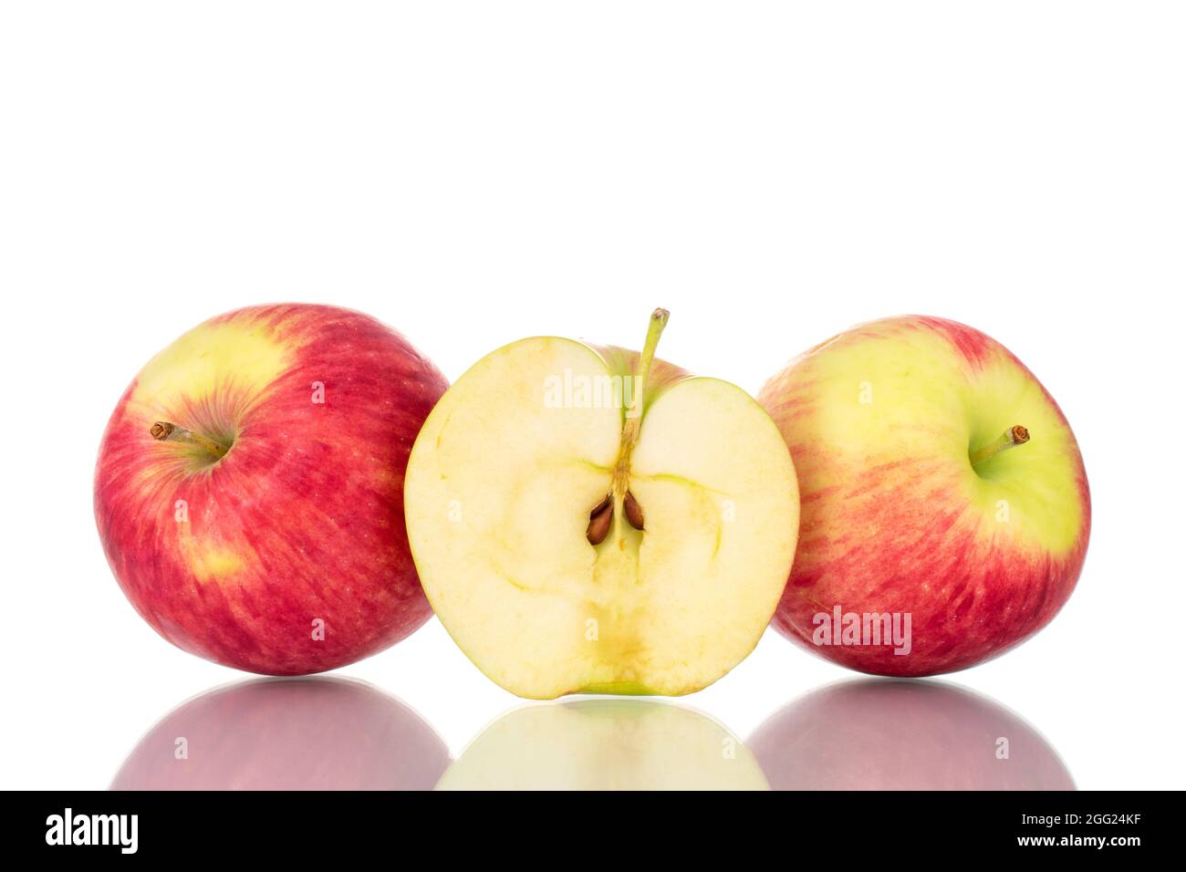 One half and two whole juicy apples, close-up, isolated on white Stock ...