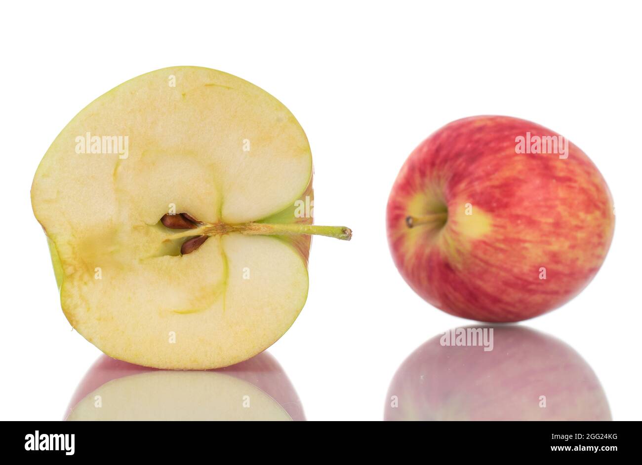 One half and one whole juicy apples, close-up, isolated on white Stock ...
