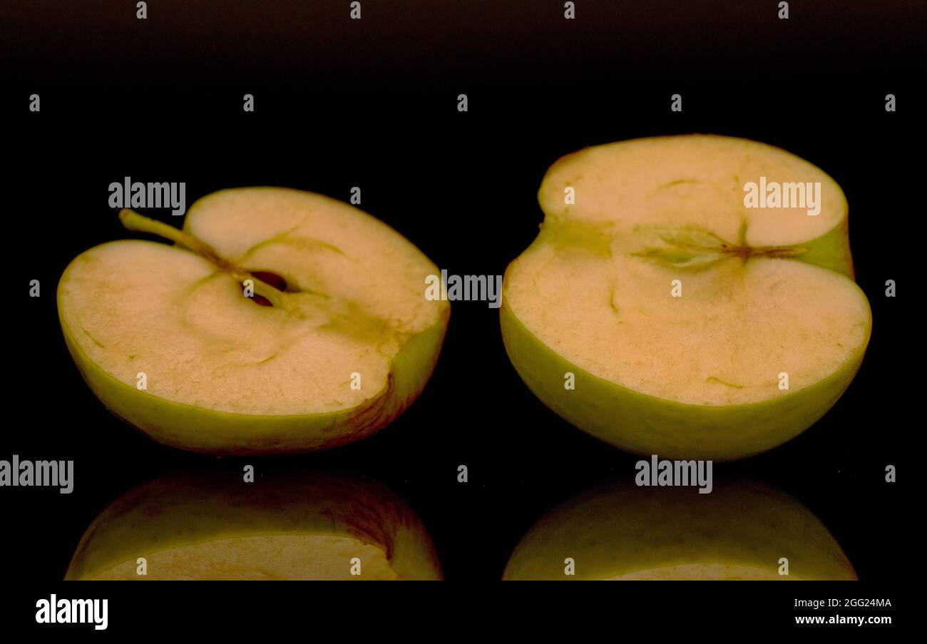 Two halves of a juicy apple, close-up, isolated on black Stock Photo ...
