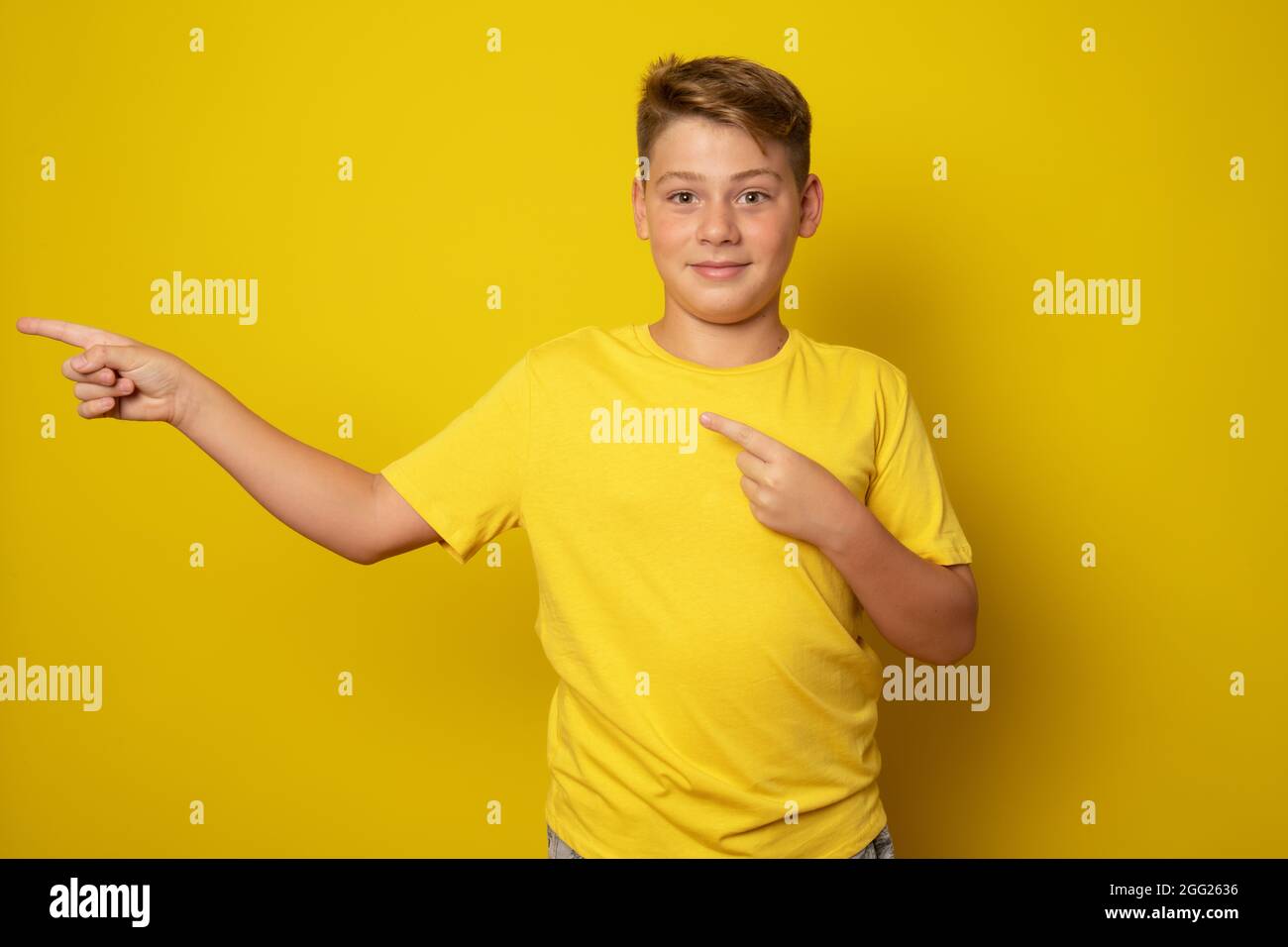 Handsome boy standing over yellow isolated background cheerful with a ...