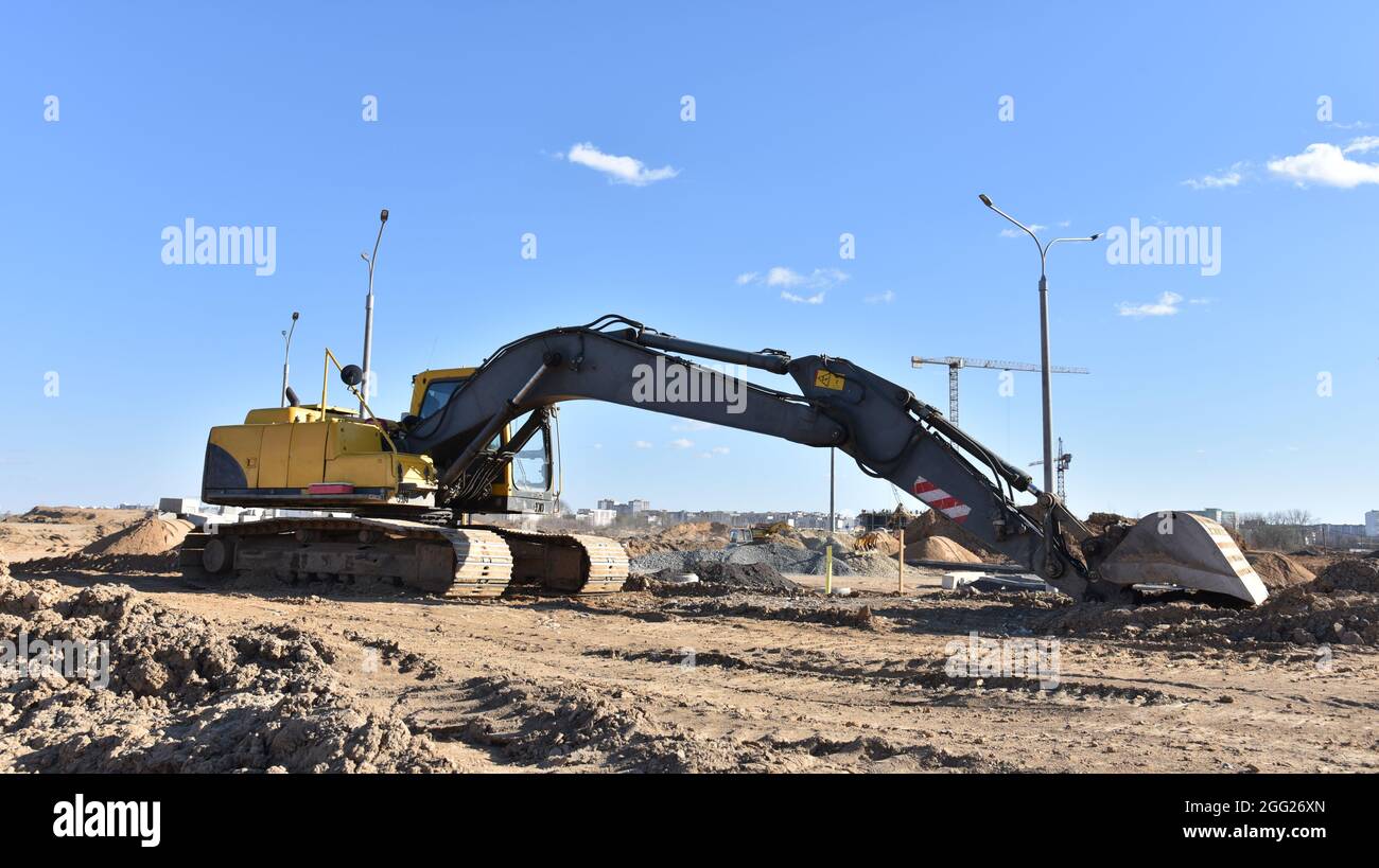 Excavator during earthmoving work at construction site Stock Photo - Alamy