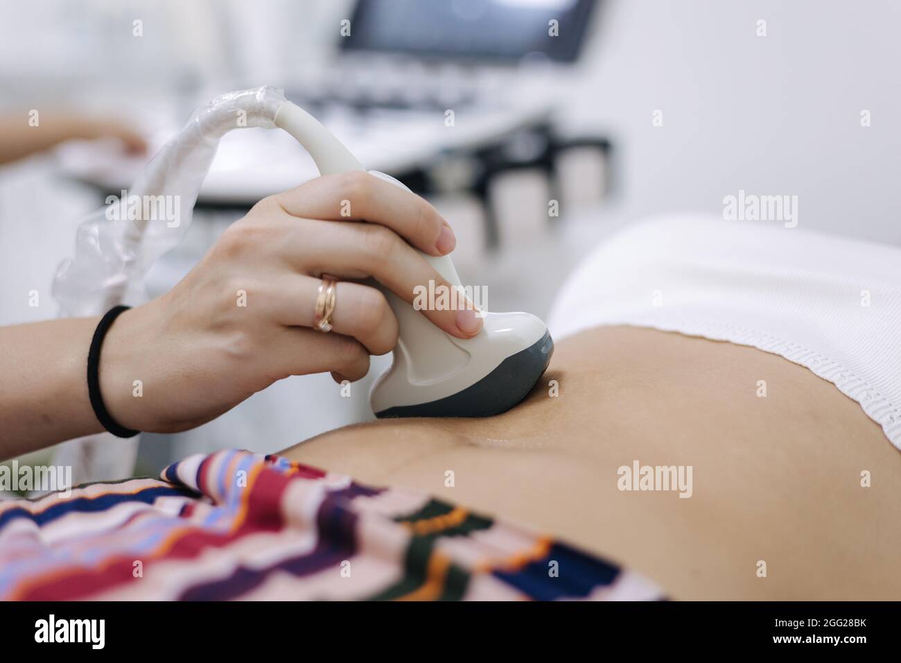 Doctor performing ultrasound explaining hi-res stock photography and ...