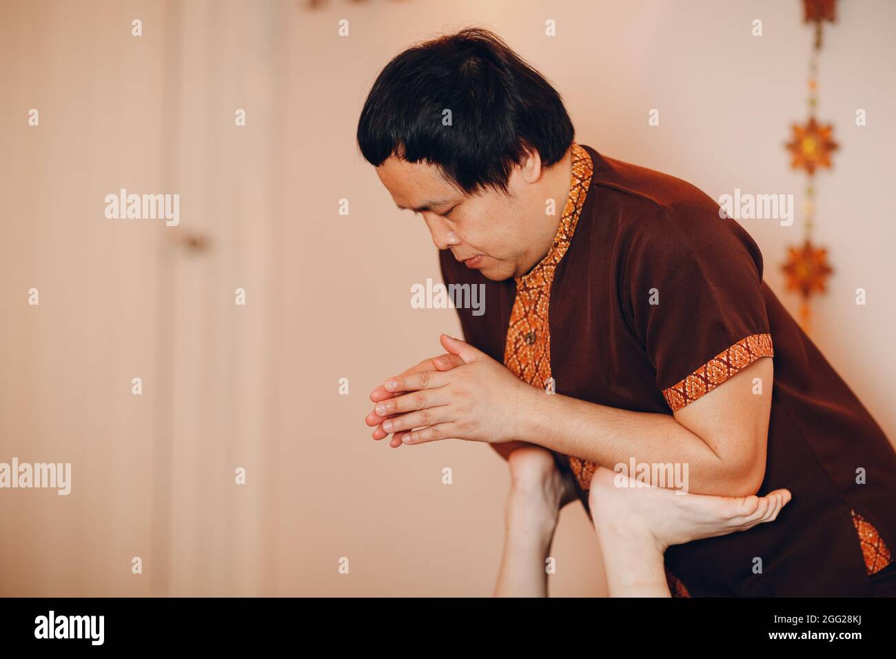 Thai man making classical thai massage procedure to young woman at ...