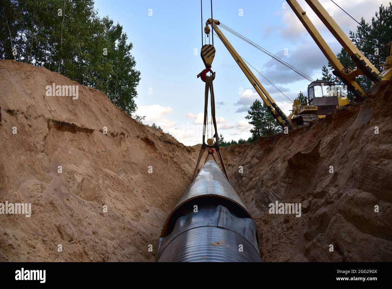Natural Gas Pipeline Construction. Laying oil pipe in a trench in the ...