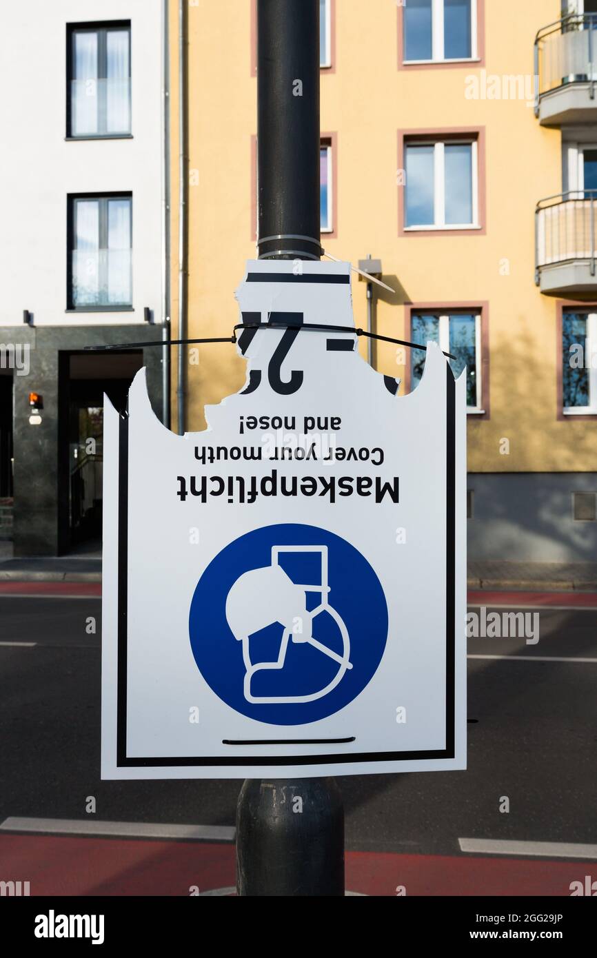 Damaged sign board with the buildings on the background Stock Photo - Alamy