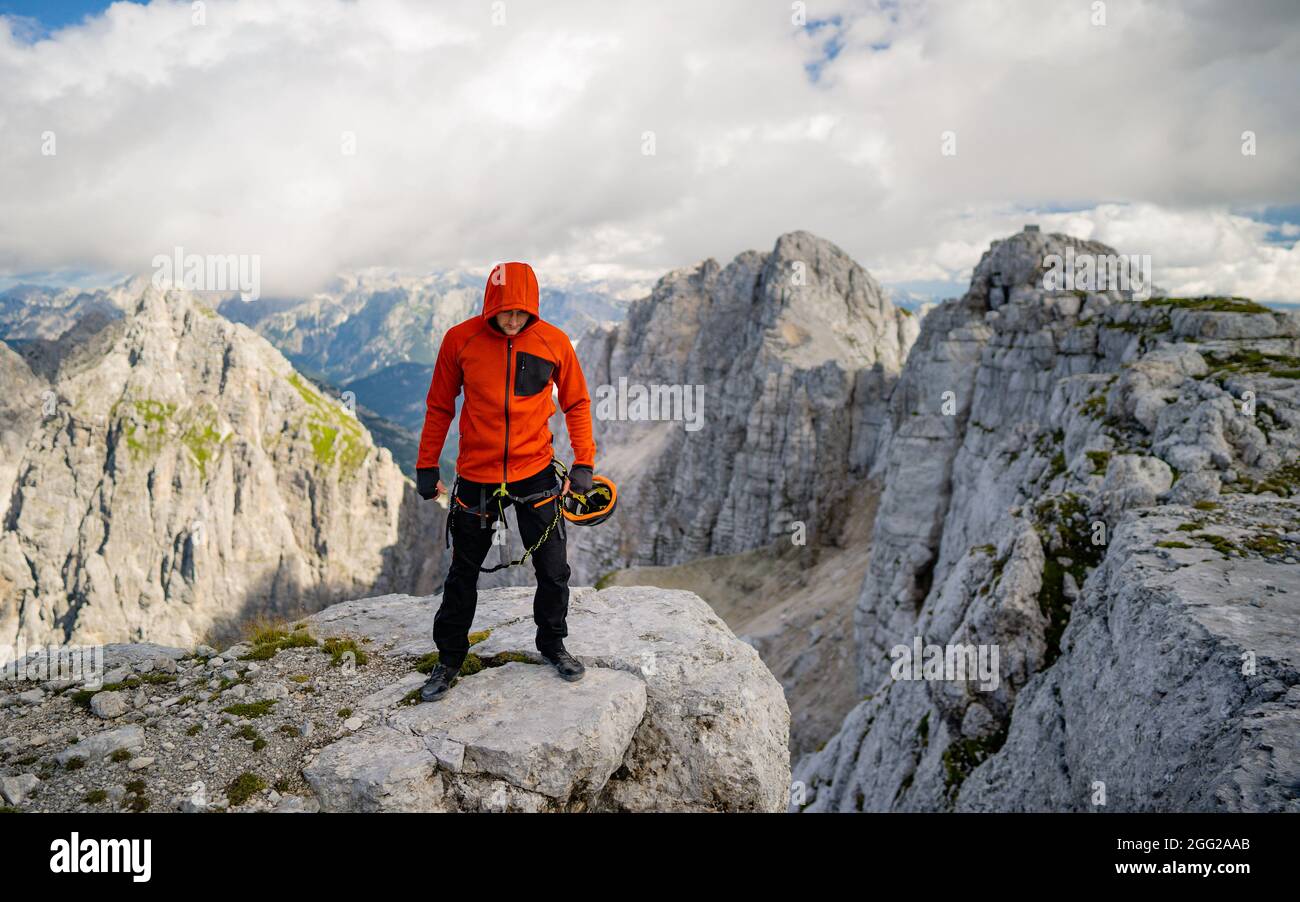 An alpinist climbing an mountain ridge. Climber ascent. Scenic ...