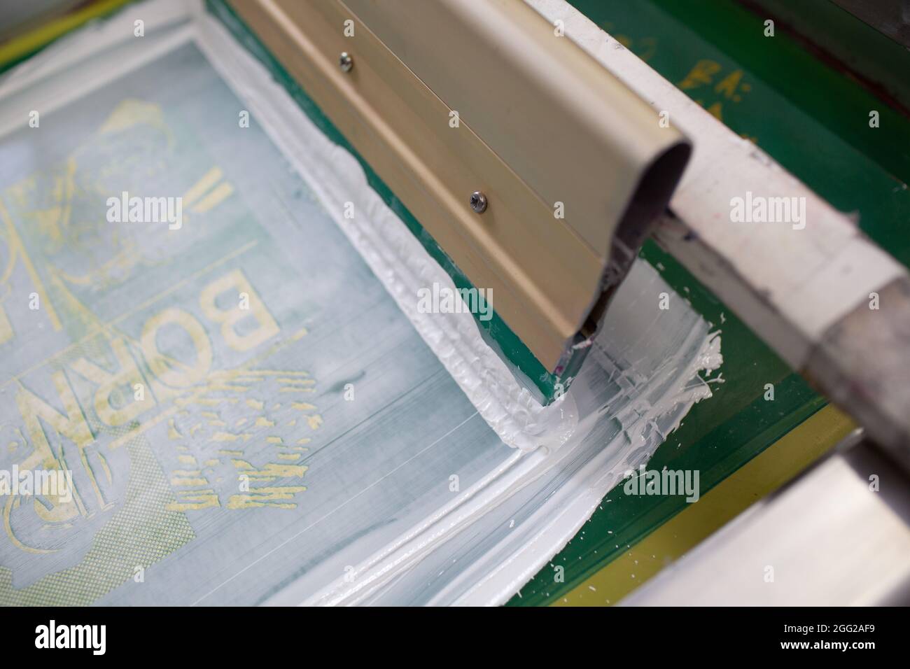 Serigraphy silk screen print process at clothes factory. Frame ...