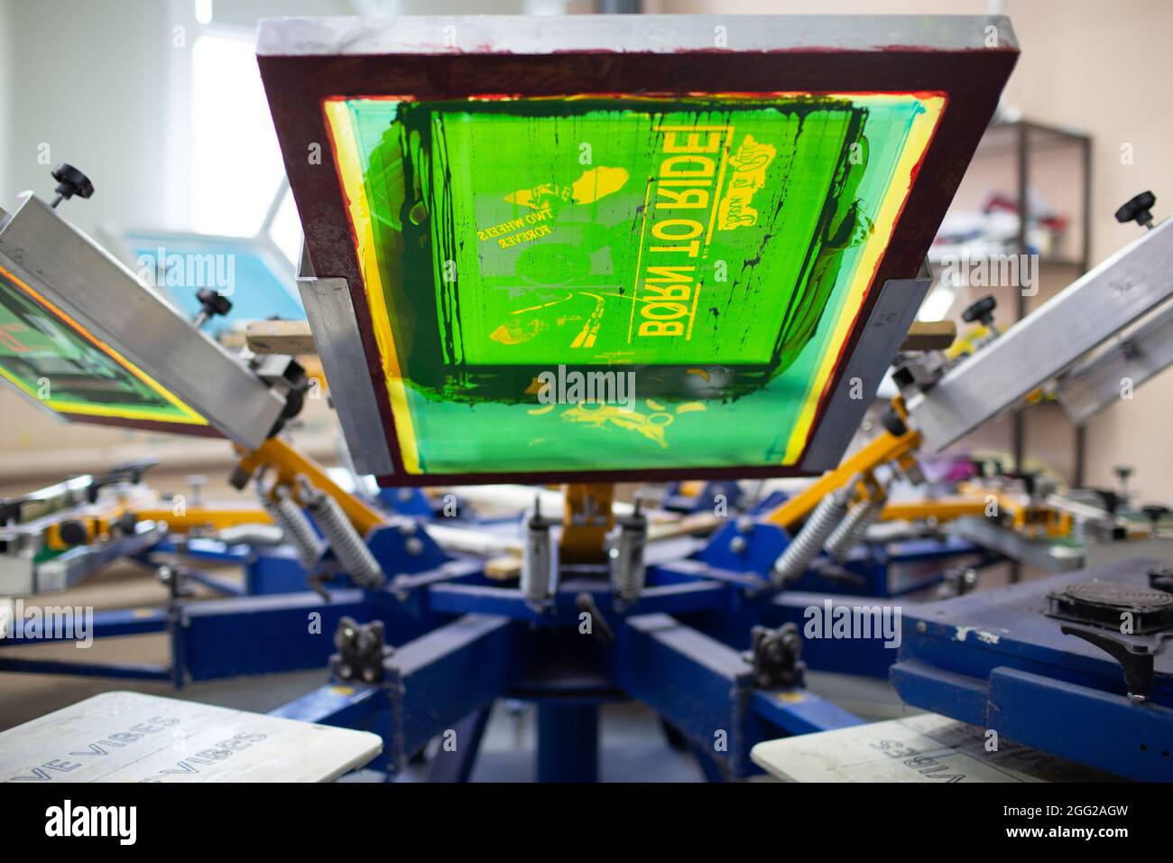 Serigraphy silk screen print process at clothes factory. Frame ...