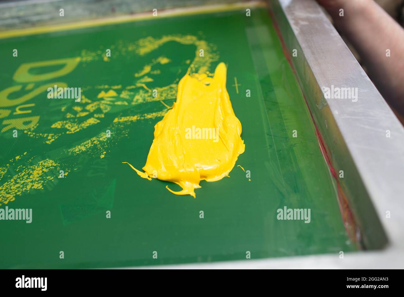 Serigraphy silk screen print process at clothes factory. Frame ...