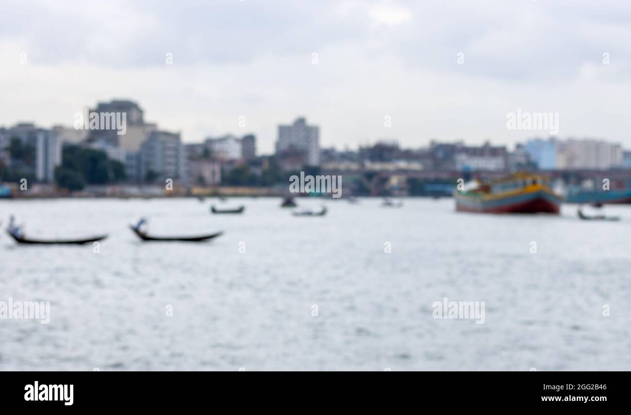 Abstract blur and defocused busy river with passing boats and trawlers ...