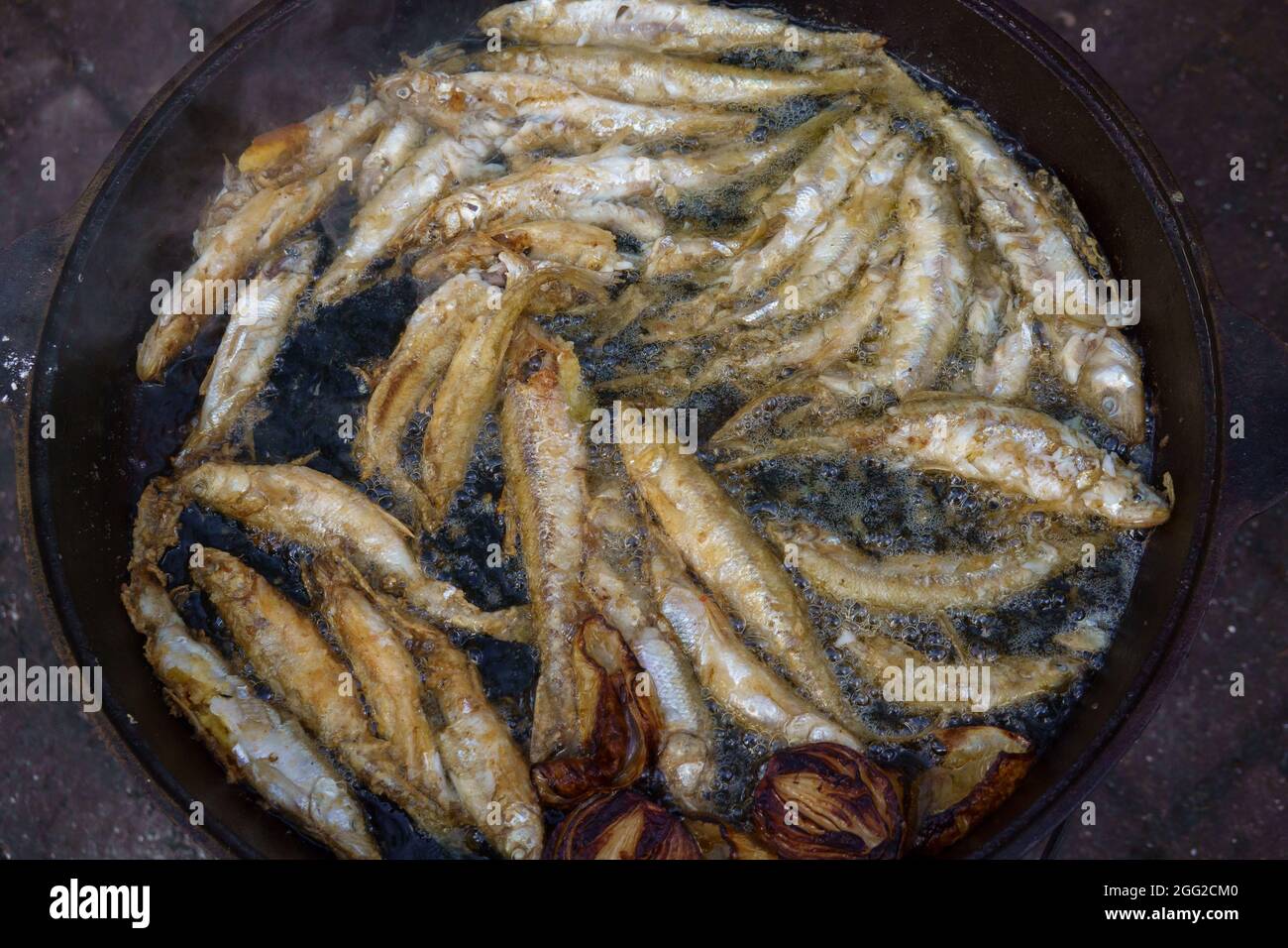 Fish frying in hot oil Stock Photo - Alamy