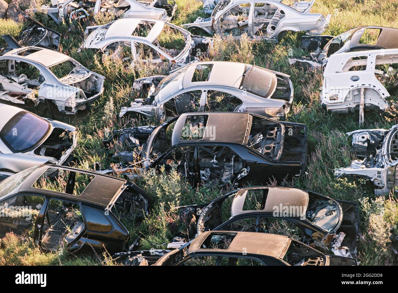 Car dump. A bunch of old rotten broken cars in the field. Top view ...