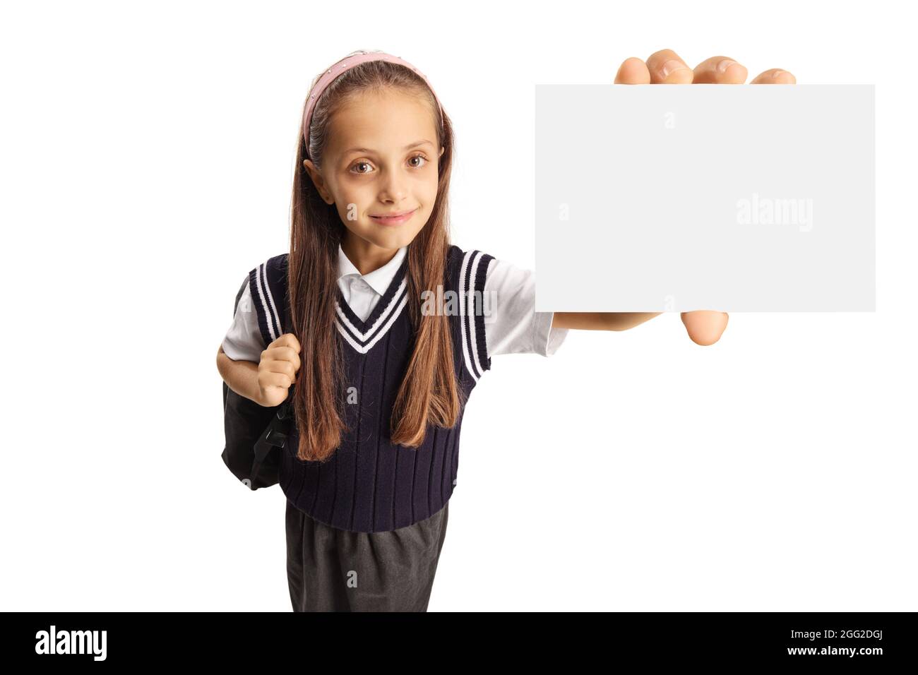 Girl in a school uniform showing a blank card in front of camera ...