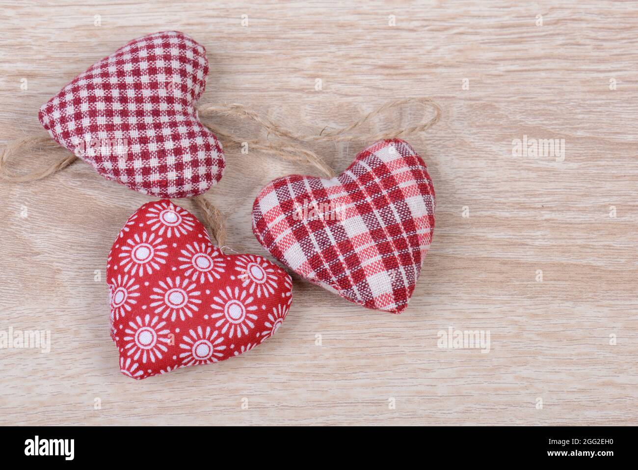 Collection of different decorated hearts on a wooden background for ...
