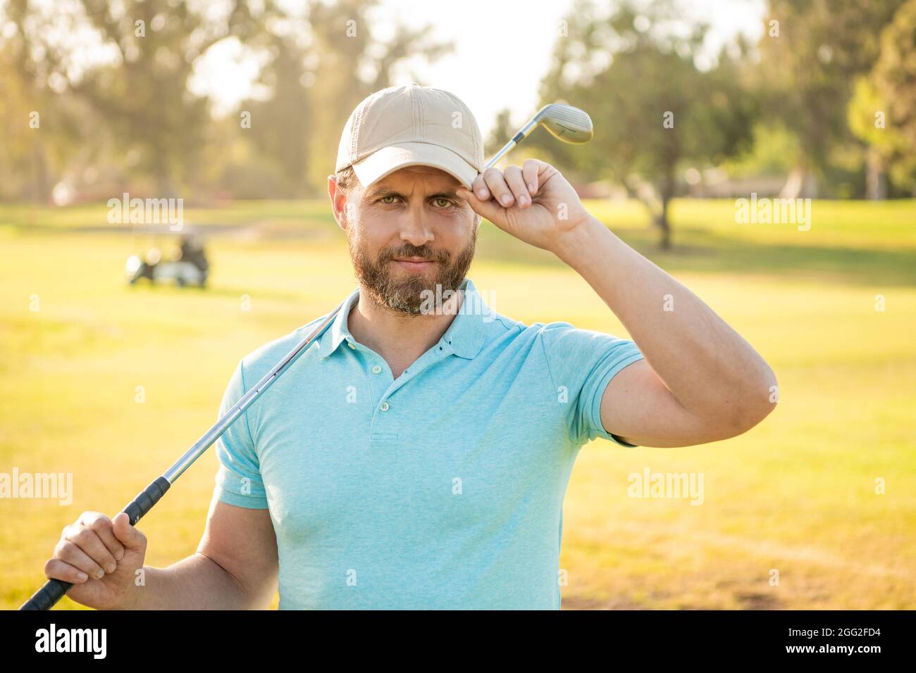 male golf player on professional golf course. portrait of golfer in cap ...