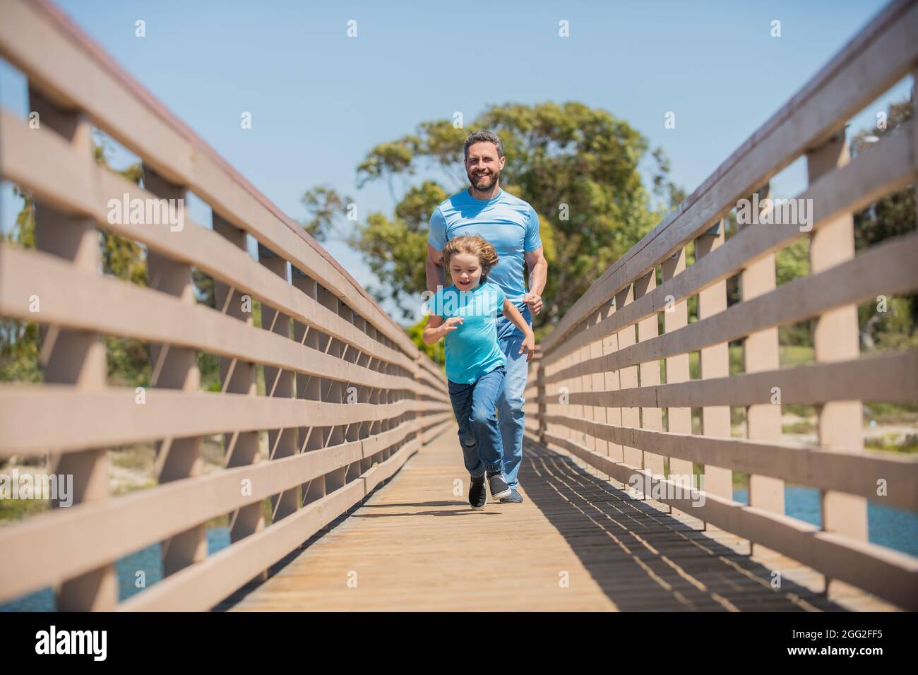 happy father running with his son outside, fun Stock Photo - Alamy