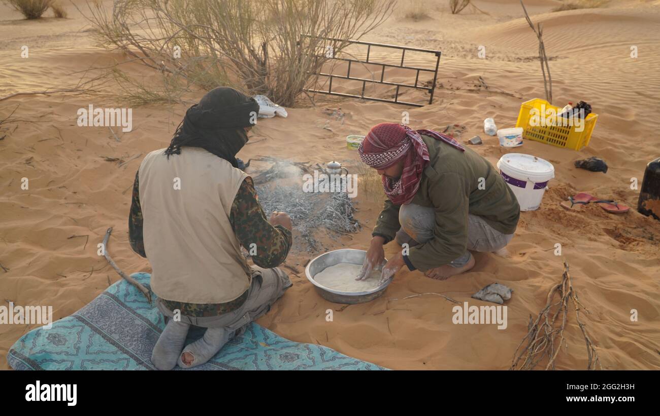 Sahara bread baking in the ground in the desert landscape of the Sahara ...
