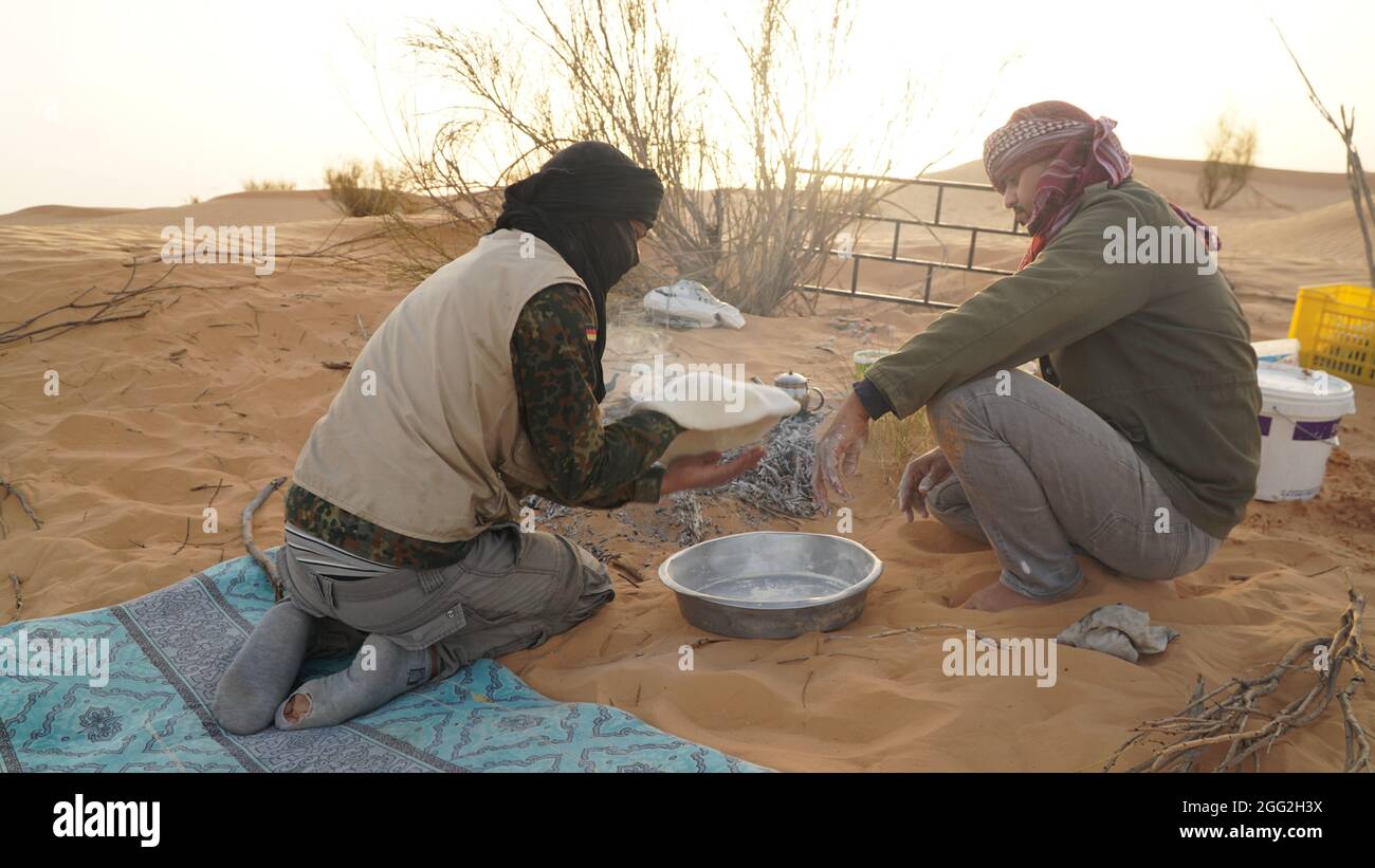 Sahara bread baking in the ground in the desert landscape of the Sahara ...
