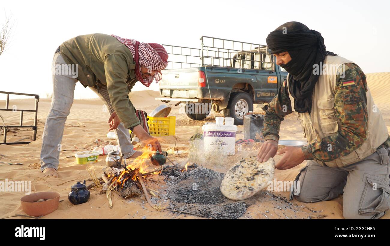Sahara bread baking in the ground in the desert landscape of the Sahara ...
