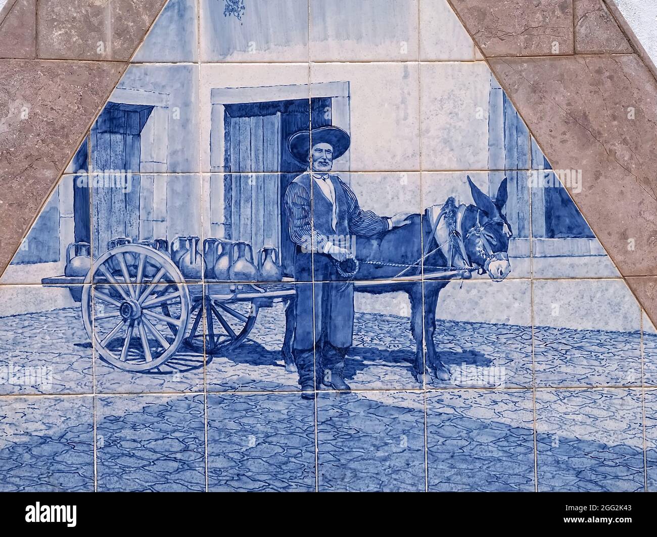 Colorful tiles of Portugal - man, donkey and cart Stock Photo - Alamy