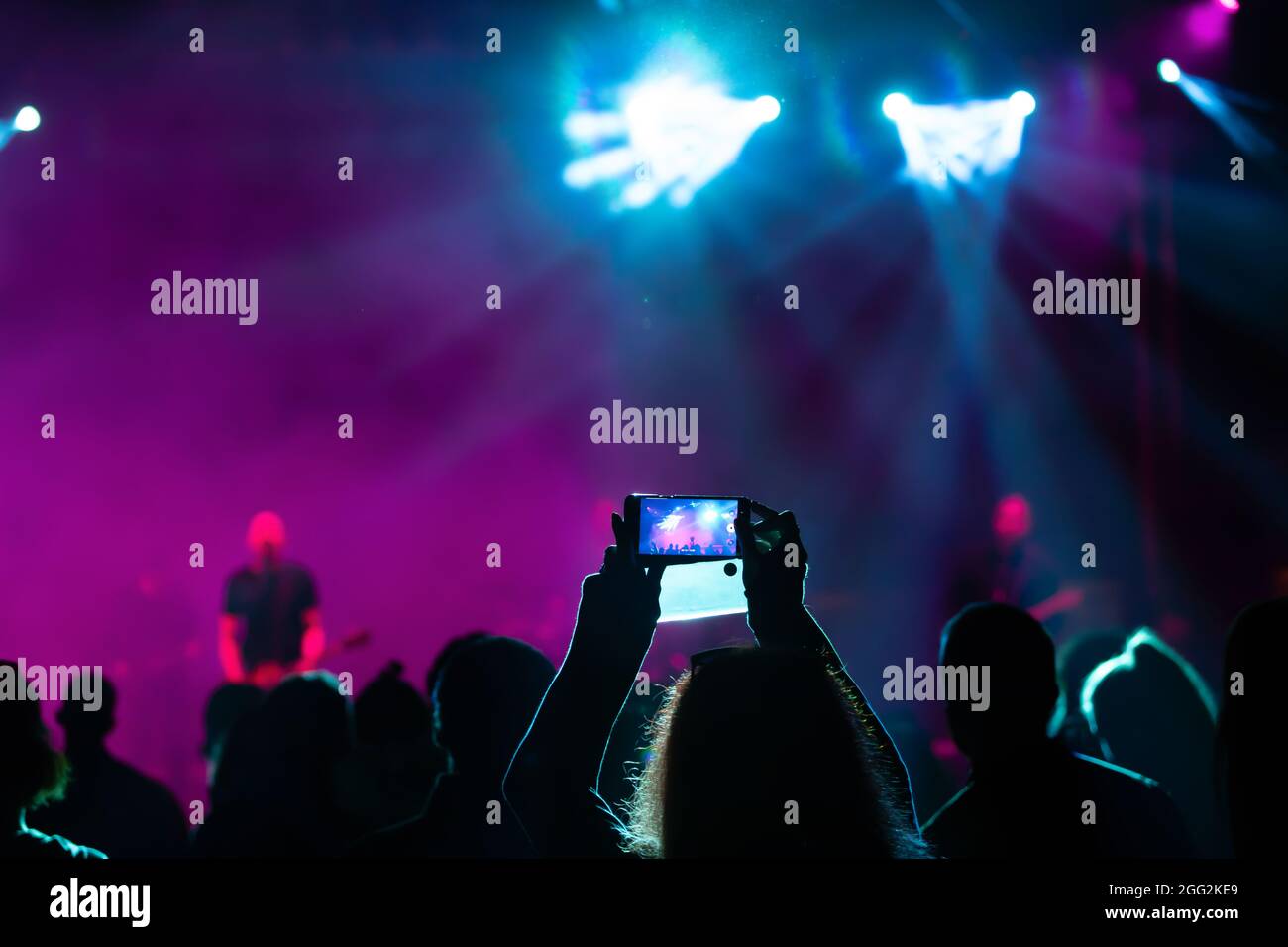 Crowd at concert - Cheering crowd in bright colorful stage lights Stock ...